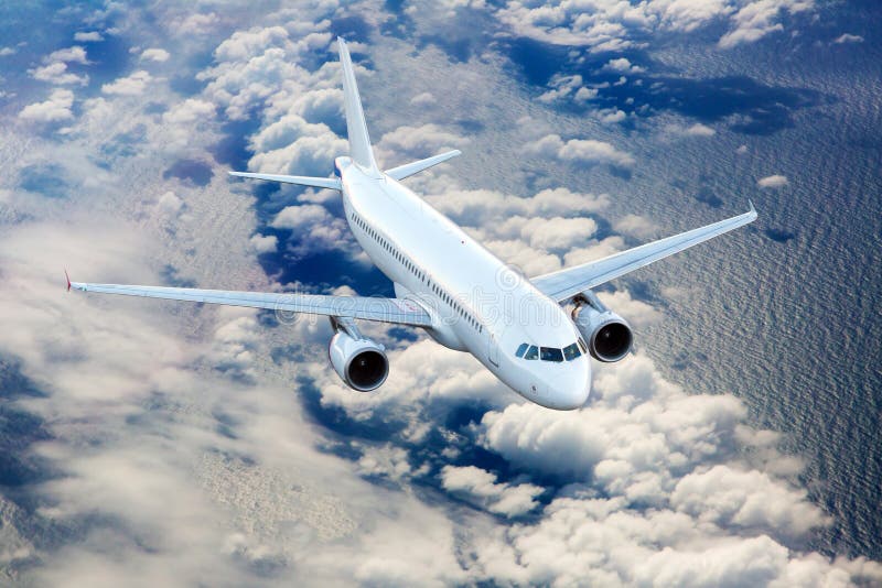 White Passenger Plane Fly High Above the Clouds and Ocean. Above View ...