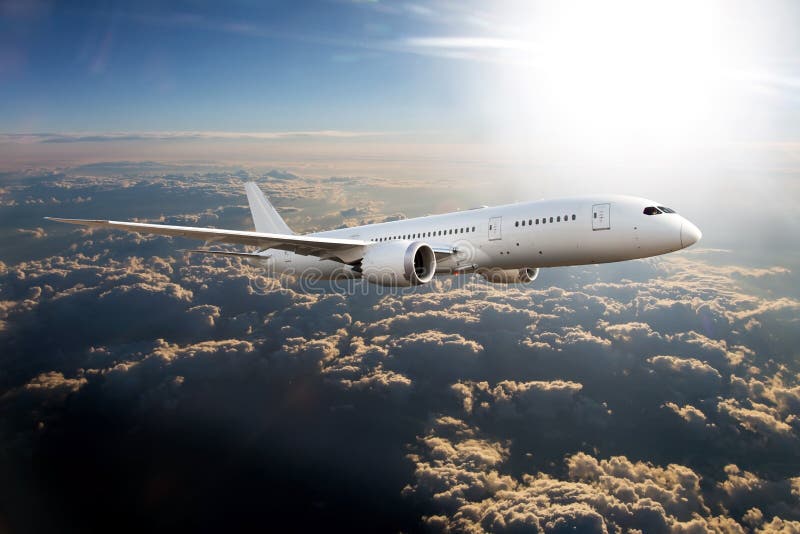 White Passenger Plane Flies High Above the Clouds through the Sun Rays ...