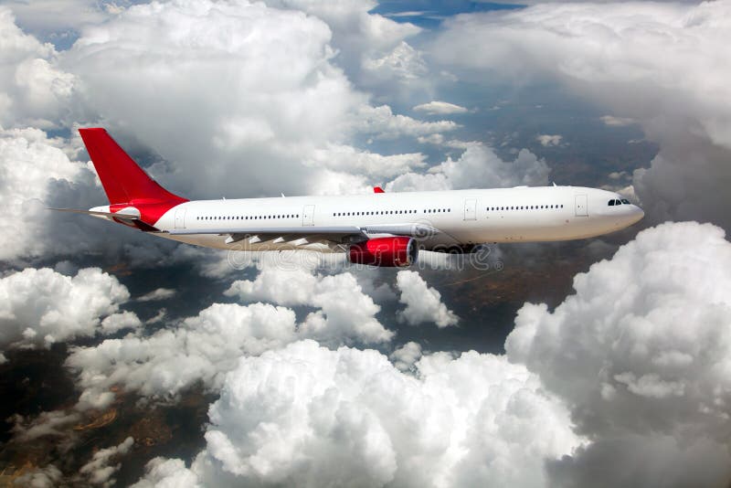 White Passenger Plane with Red Tail Flying Over the Clouds Stock Photo ...