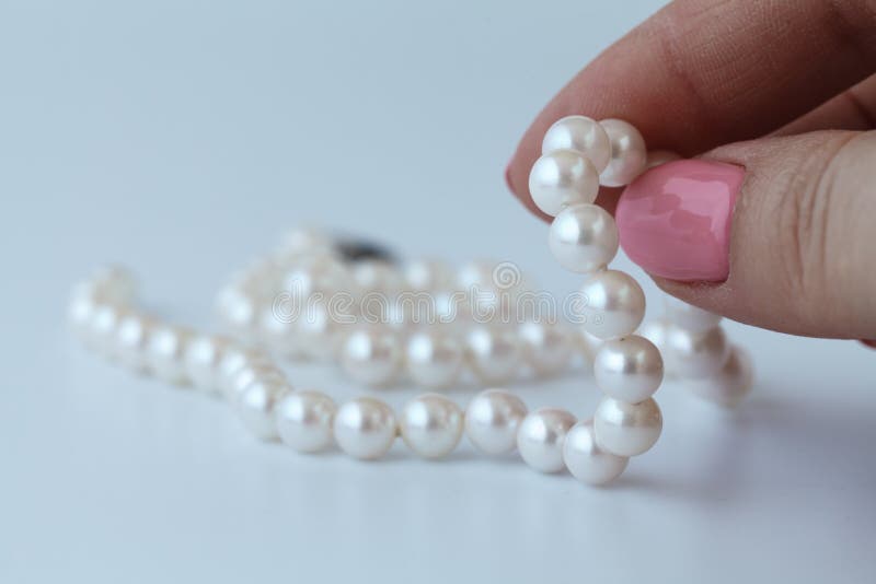 White pearl in female hand stock image. Image of beauty - 112468809
