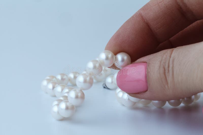 White pearl in female hand stock photo. Image of care - 112468900