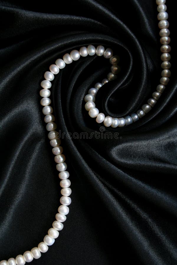 White Pearls on the Black Silk As Background Stock Photo - Image of ...