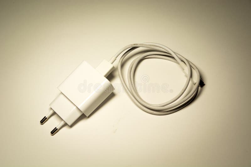 White Phone Charger with Rolled-up Cable Stock Image - Image of charger ...