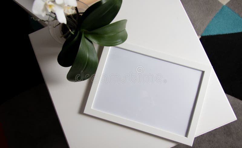 White Photo Frame on the Table. White Blank Photo Frame on the Table ...