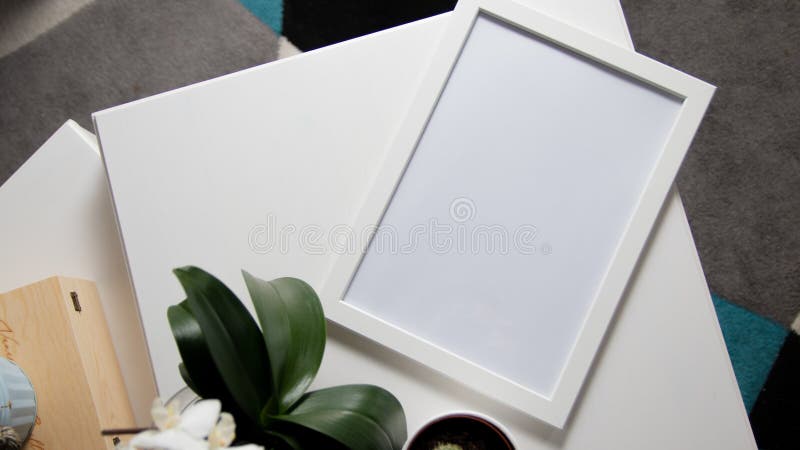White Photo Frame on the Table. White Blank Photo Frame on the Table ...