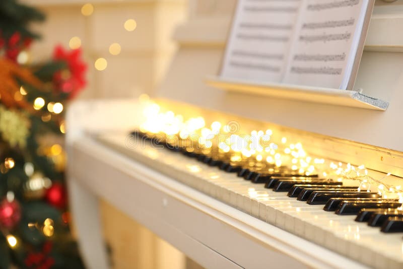White Piano with Festive Decor and Note Sheets Indoors. Christmas Music ...