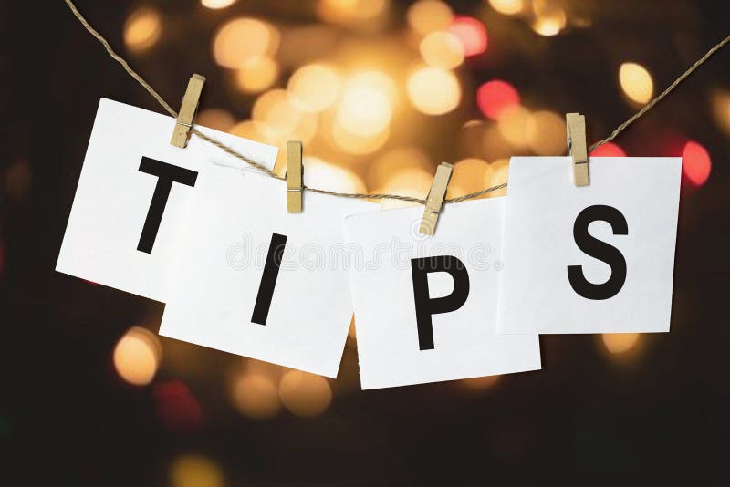 Text Tips and Tricks on White Paper in Hand Isolated on Blue Background ...