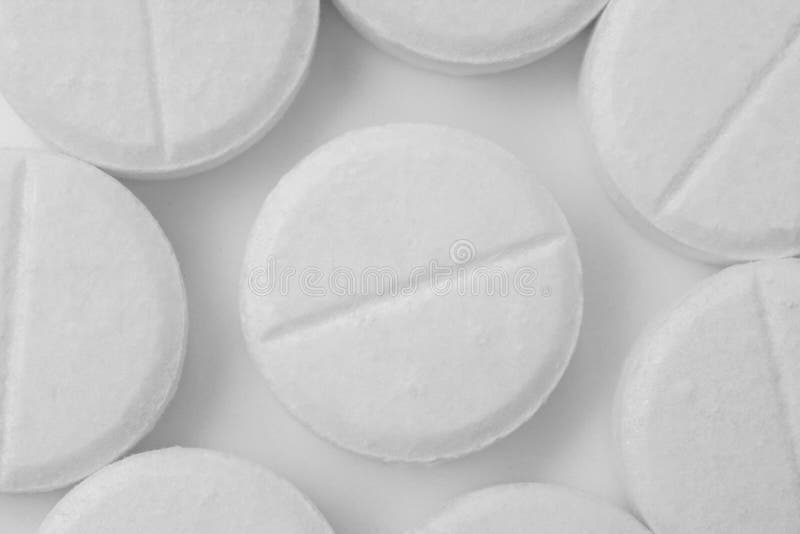 White Pills with a Line in the Middle on a White Background, Texture of ...
