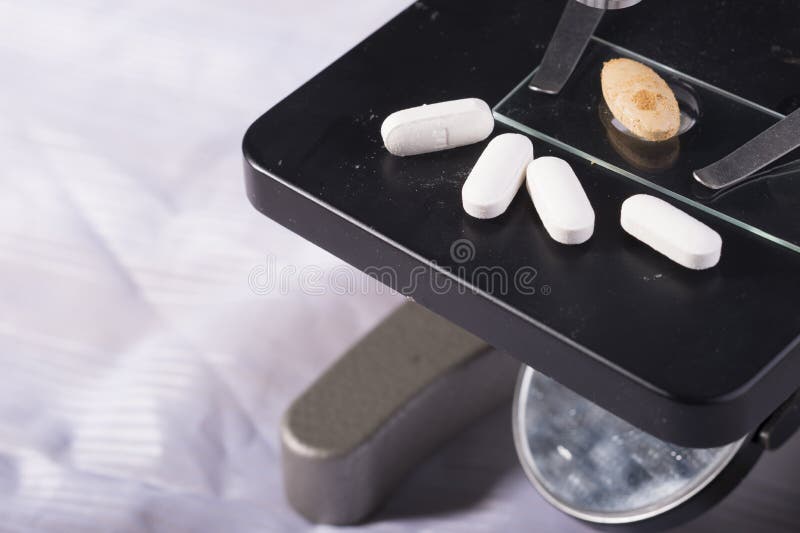 White Pills Microscope stock photo. Image of medicament - 57602770