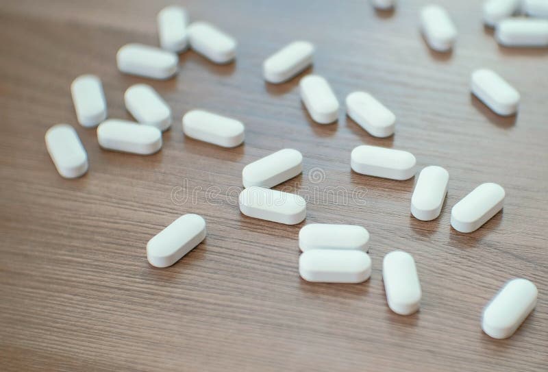 White pills on the table. stock image. Image of healthy - 115328805