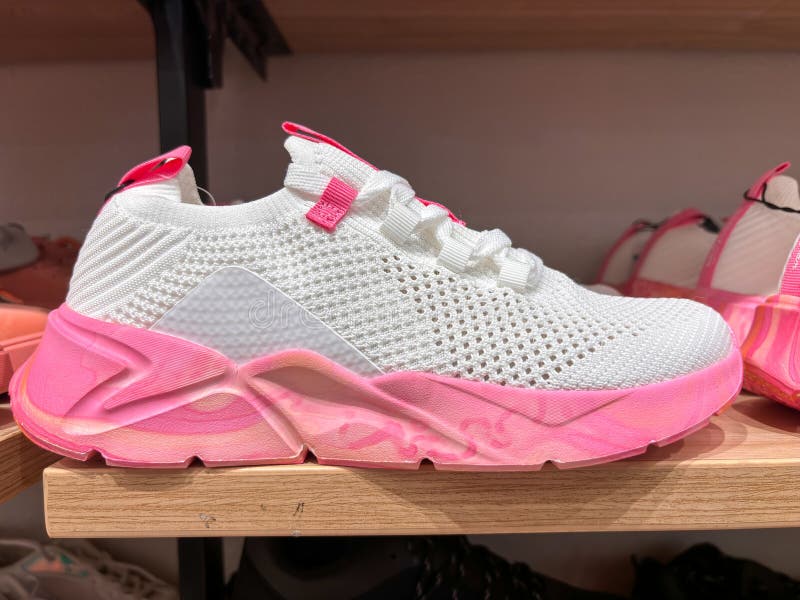 A White and Pink Shoe with a Pink Stripe on the Side Stock Photo ...