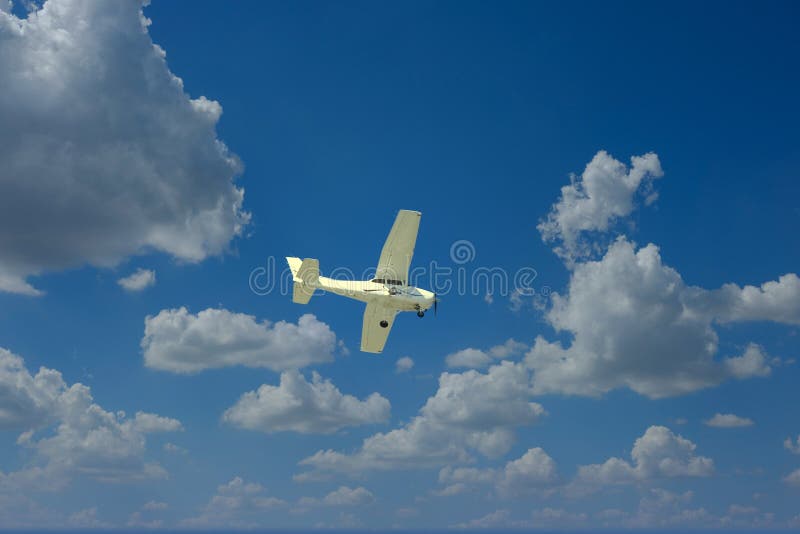 White Plane from Below on PUffy Clouds Stock Photo - Image of transport ...