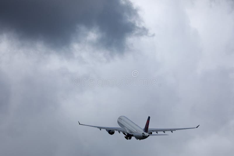 White Plane Flying Up in the Dark Sky Editorial Stock Photo - Image of ...