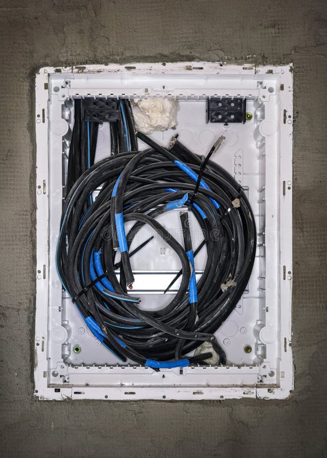 White Plastic Cables Box with Black Wires Installed on New Gray Wall at ...