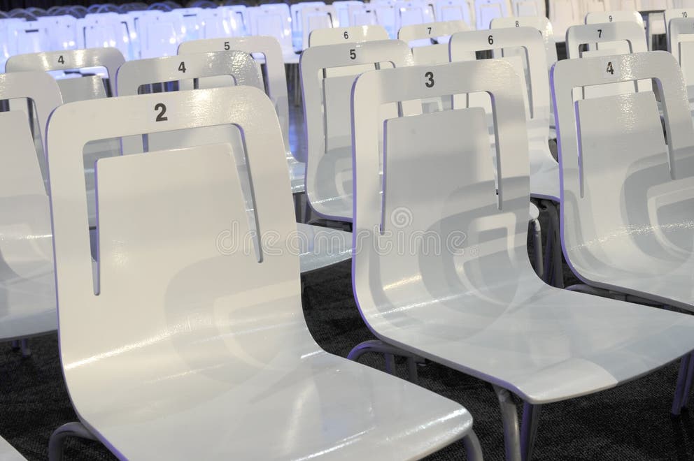 White Plastic Chairs with Numbers Stock Photo - Image of presentation ...