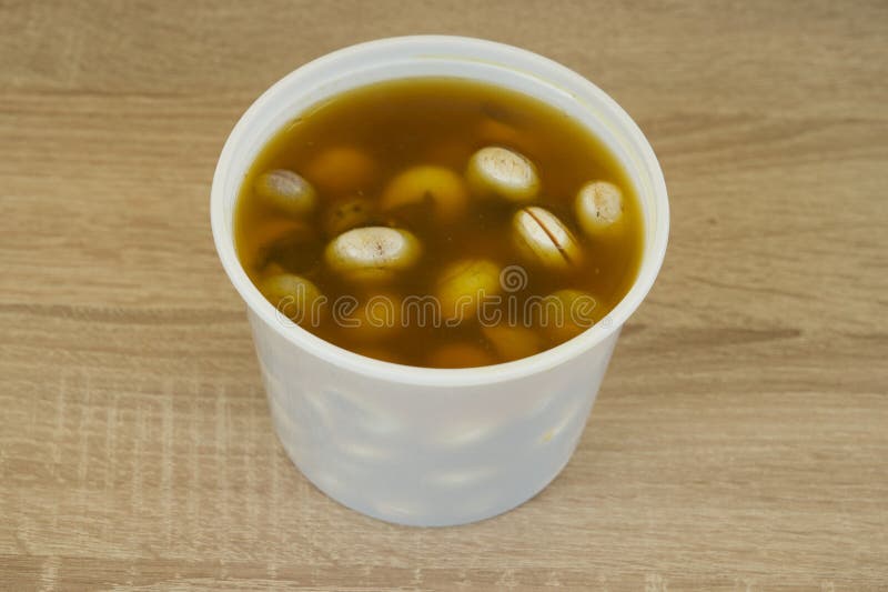 A White Plastic Container with a Brown Liquid Inside Stock Image ...