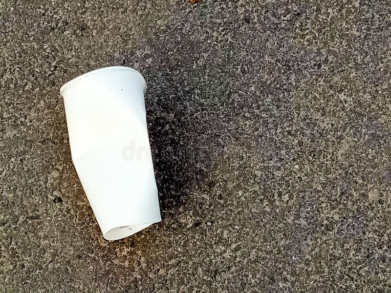 A White Plastic Cup Thrown Like Garbage on the Pavement. Plastic ...