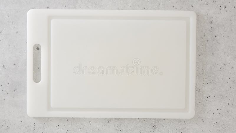 White Plastic Cutting Board Close-up on a Gray Stone Kitchen Countertop ...