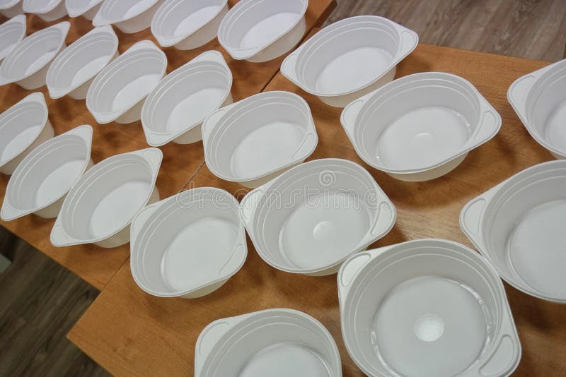 White Plastic Deep Disposable Plates Stand on a Wooden Table. Zero ...