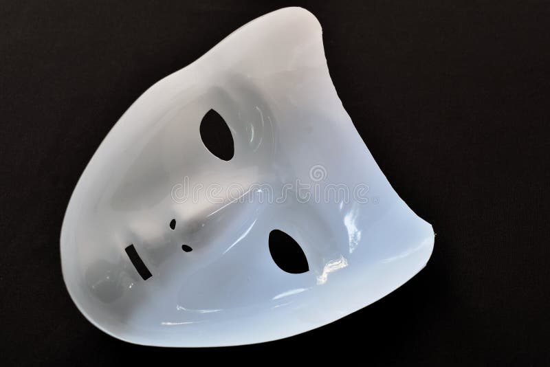 White Plastic Human Face Mask on Black Fabric Background Stock Image ...