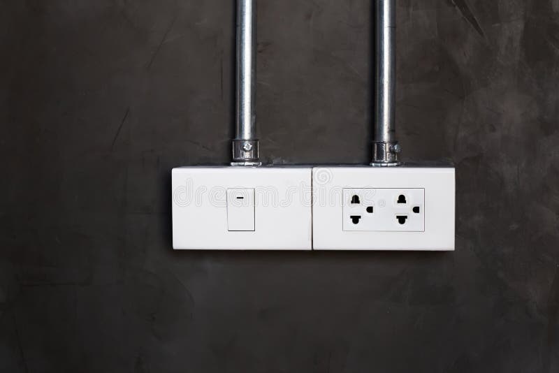 White Plastic Light Switch Turned on and White 2 Power Sockets on ...