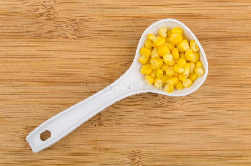 White Plastic Spoon with Sweet Corn on Wooden Table Stock Image - Image ...