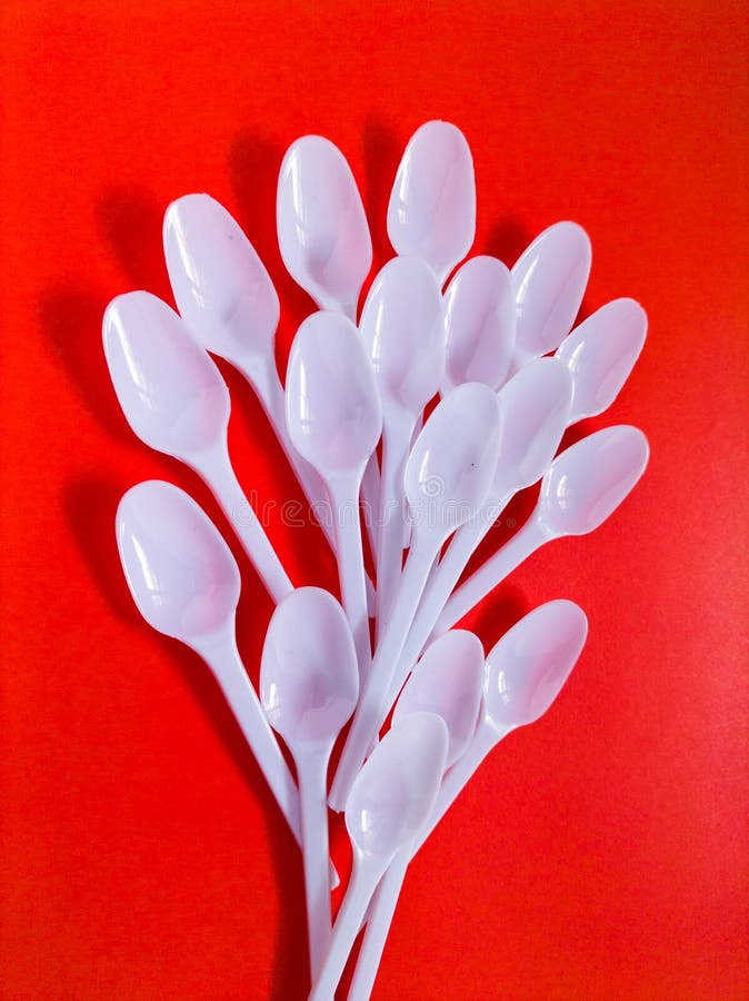 White Plastic Spoons on Red Background. Stock Photo - Image of shiny ...