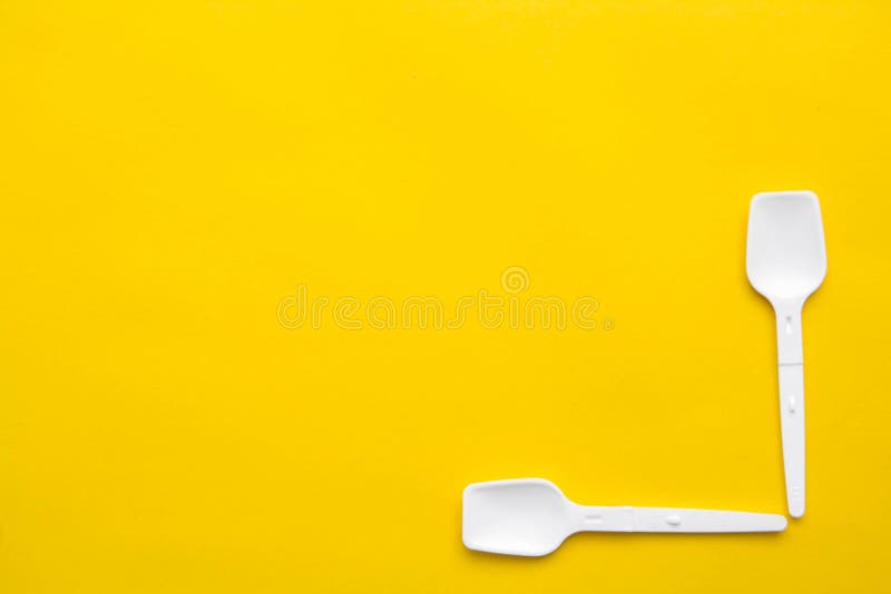 White Plastic Spoons on Yellow Background. Fast Food, Eco and No ...