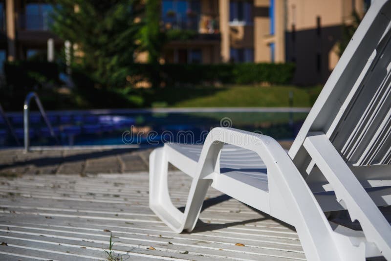 White Plastic Sun Beds by the Pool. Stock Image - Image of beds, chairs ...