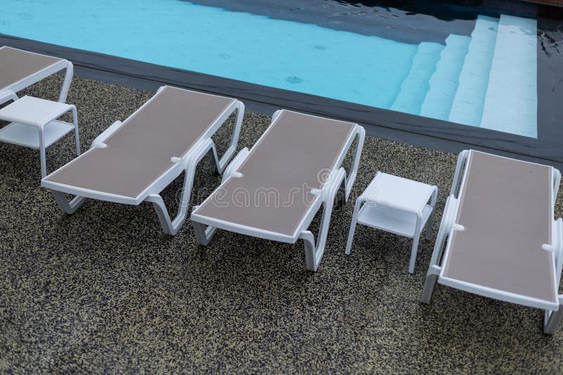 White Plastic Sunbeds by the Pool Stock Image - Image of heat, leisure ...