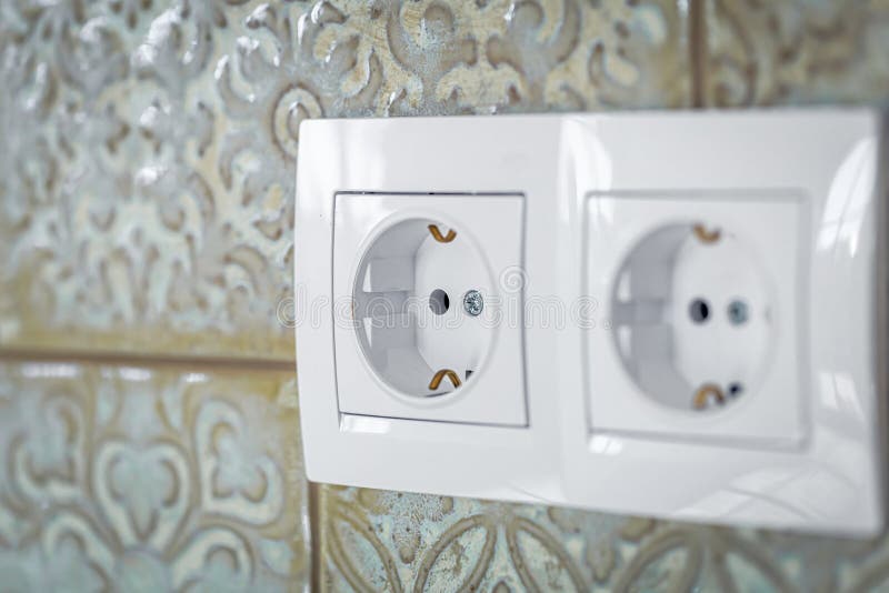 White Plastic Walk-through Switches and Sockets on a White Wall. Stock ...