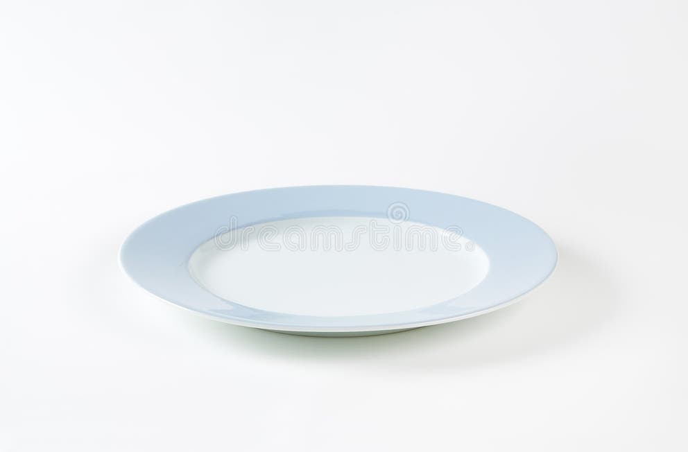 White plate with blue rim stock image. Image of single - 49504027