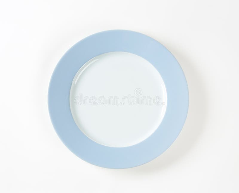 White plate with blue rim stock image. Image of isolated - 49504627