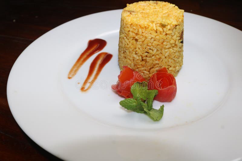 White Plate of Cup Rice Decoration with Tomato Sauce and Make Tomato ...