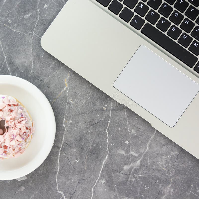 White Plate with Donut and Laptop Keyboard on Concrete Table Stock ...
