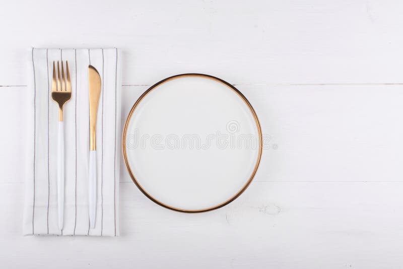 White Plate with a Gold Border on White Table Stock Photo - Image of ...
