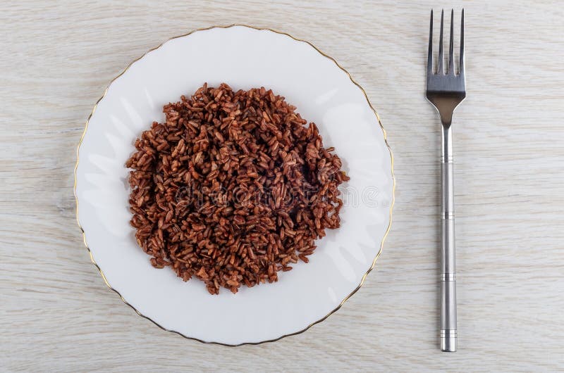 Plate with Red Boiled Rice, Fork on Table. Top View Stock Image - Image ...