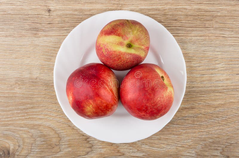 White Plate with Ripe Nectarines on Wooden Table Stock Image - Image of ...