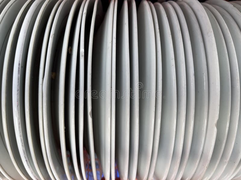 White Plates Being Stacked Together in a Plastic Basket. Stock Image ...
