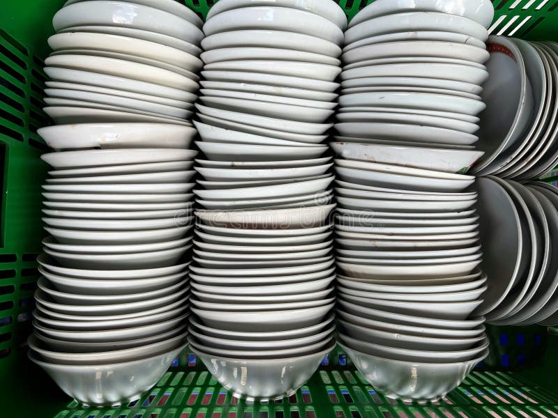 White Plates Being Stacked Together in a Plastic Basket. Stock Image ...