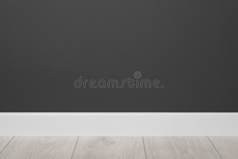 White Plinth on Laminated Floor Near Black Wall Indoors Stock Photo ...