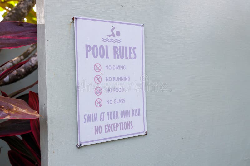 White Pool Rules Sign Mounted on a Light-colored Wall with Purple ...