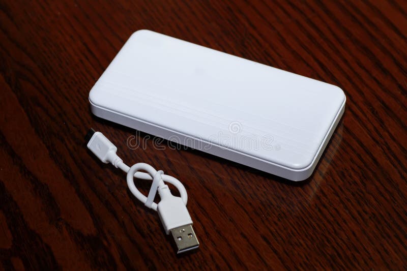 A White Portable Mobile Power Bank on the Table. Stock Image - Image of ...