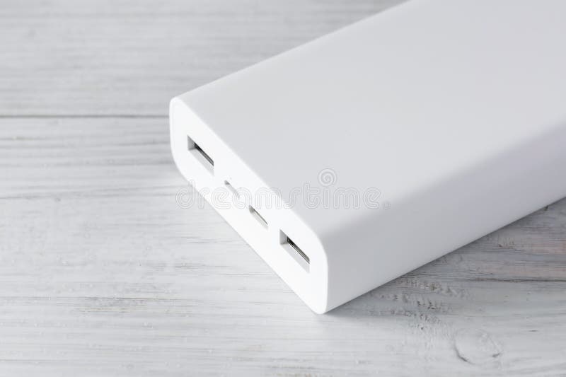 White Portable Power Bank on a Wood Table Stock Photo - Image of supply ...