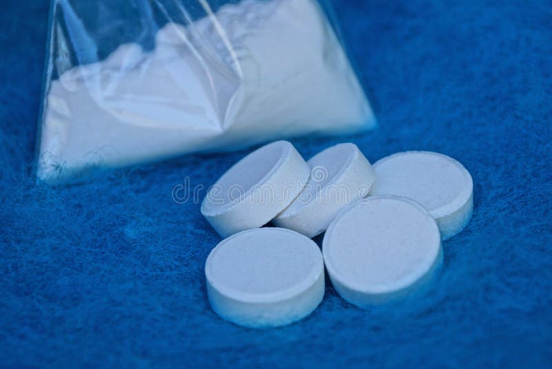 White Powder in a Bag and a Bunch of Pills on Blue Wool Stock Photo ...