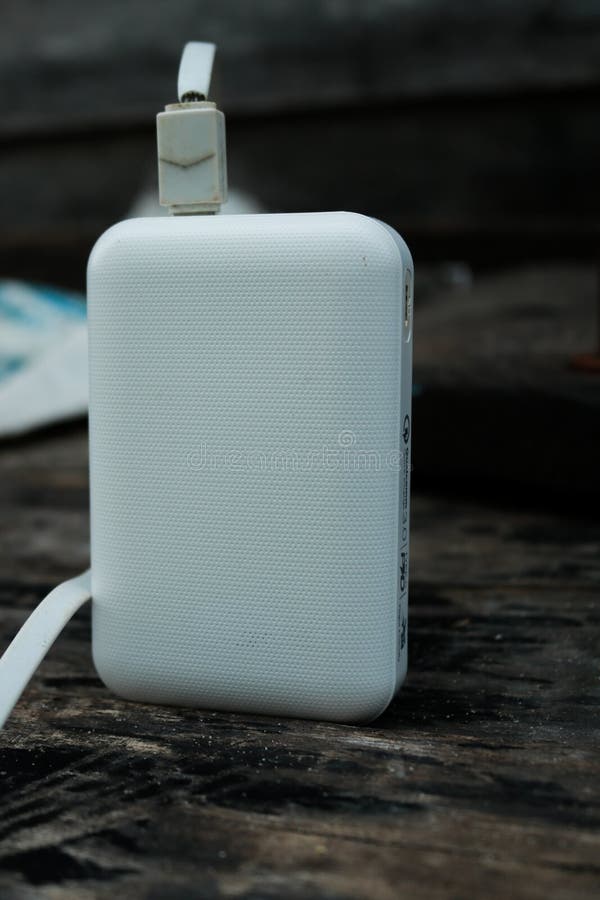 White Power Bank Electronic with Data Cable on Woodrn Table Stock Image ...