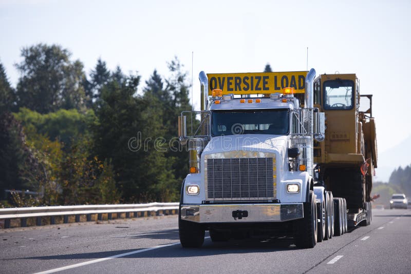 Big Rig Semi Truck with Oversize Load Sign and Step Down Trailer Stock ...
