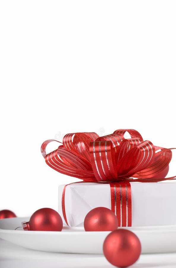 White Present with Red Ribbons on a Dinner Plate Stock Photo - Image of ...