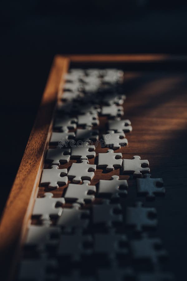White Puzzle Pieces on a Table, Sunlight from the Window Over it ...