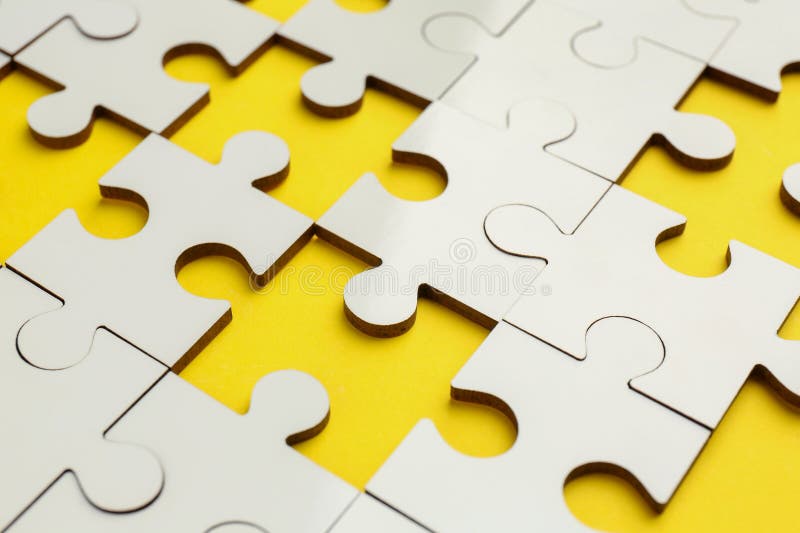 White Puzzle Pieces on Yellow Background, Closeup Stock Photo - Image ...